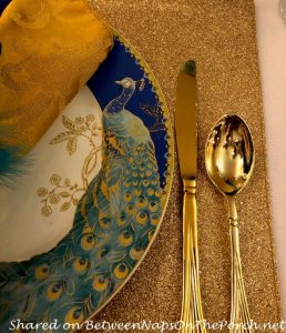 A Celebratory Table Setting in a Beautiful Peacock Theme of Blue and Gold